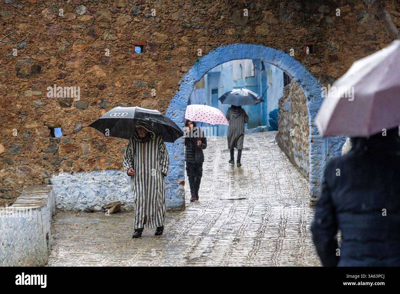 People with umbrellas in Bab El Onsar, 16th century gate, Ras el Maa ...