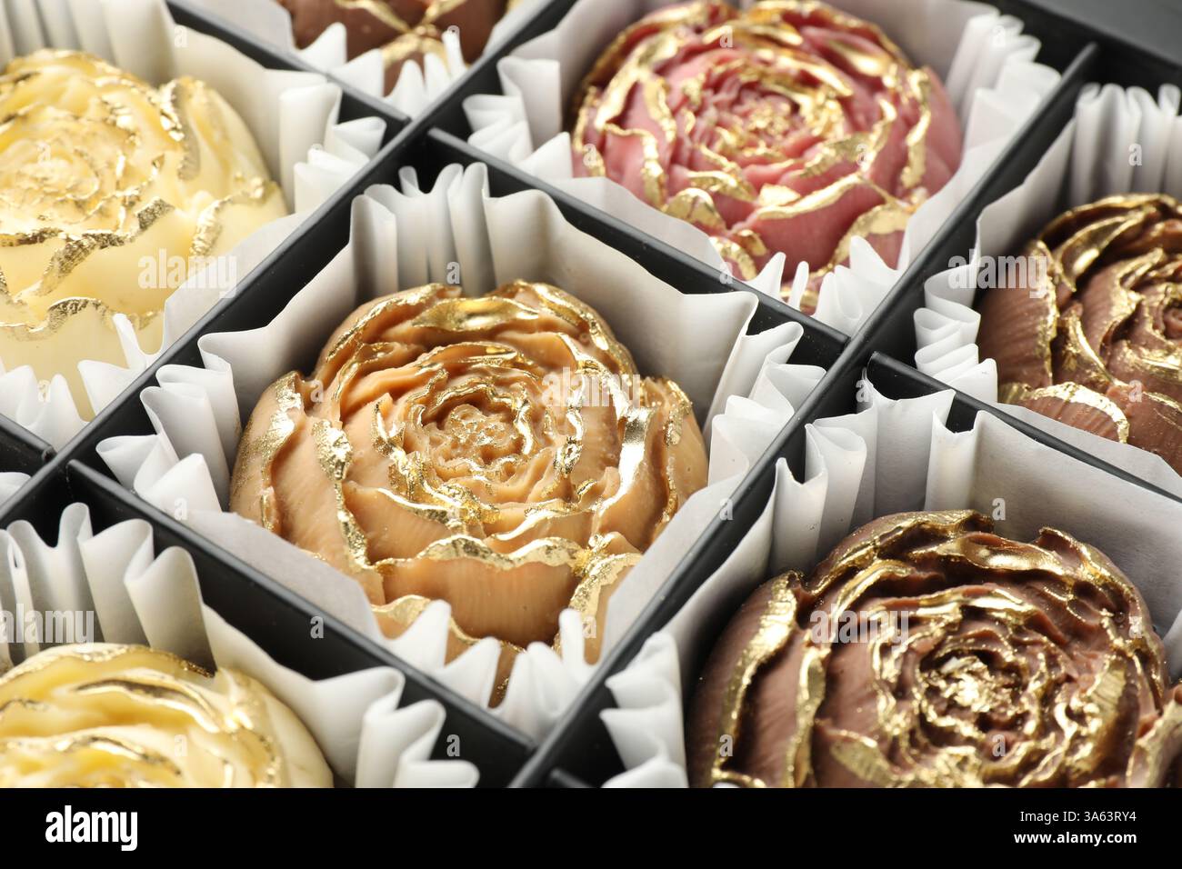 Flower shaped chocolate bonbons in box, closeup Stock Photo - Alamy