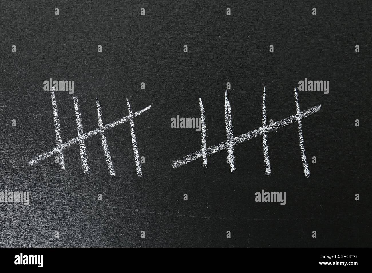 Counting days by drawing sticks with chalk on blackboard, closeup Stock ...
