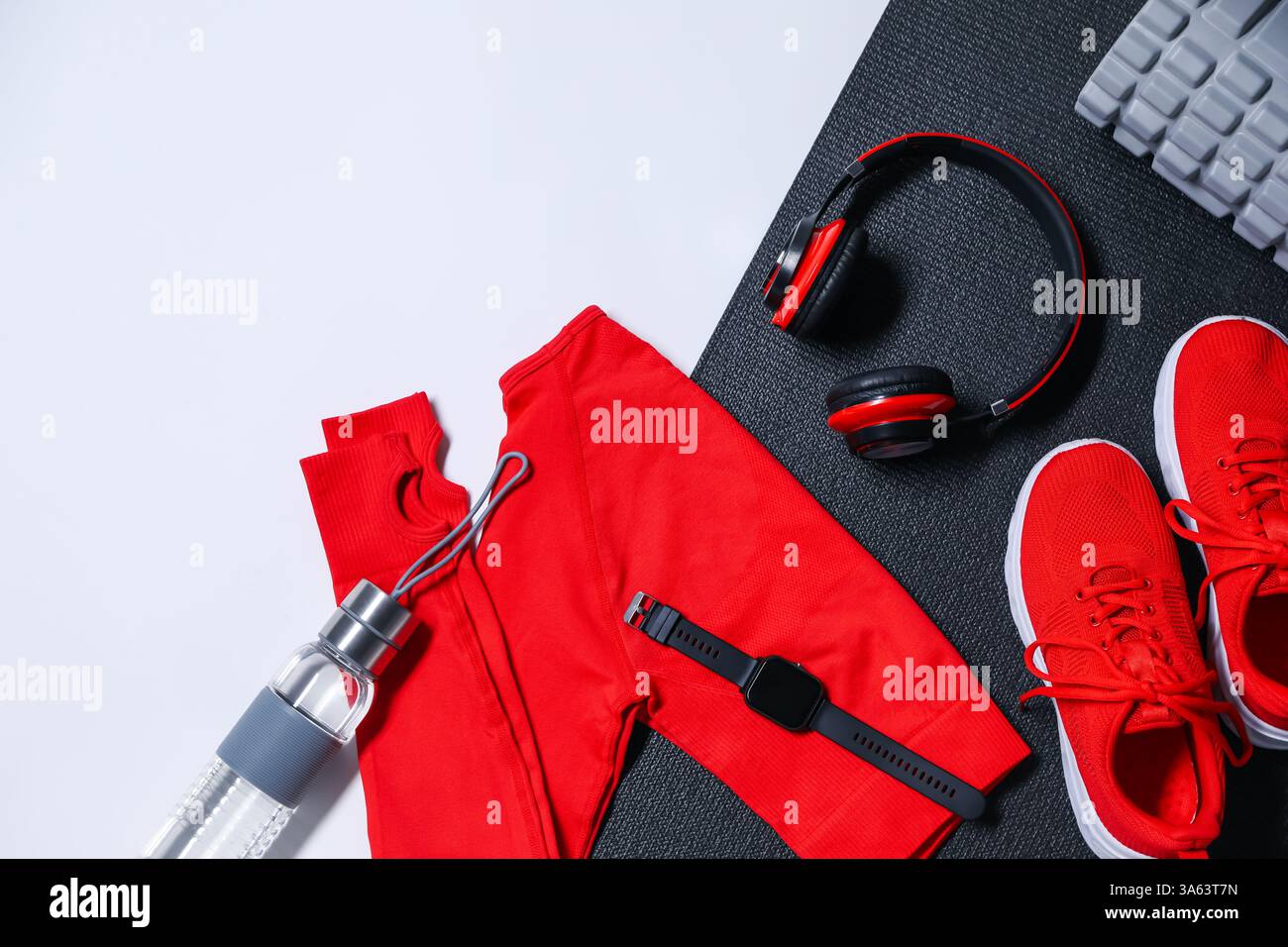 Different gym stuff and headphones on white background, flat lay. Space ...