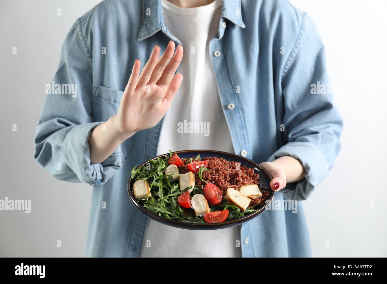 Woman refusing to eat meal on white background, closeup. Food allergy ...