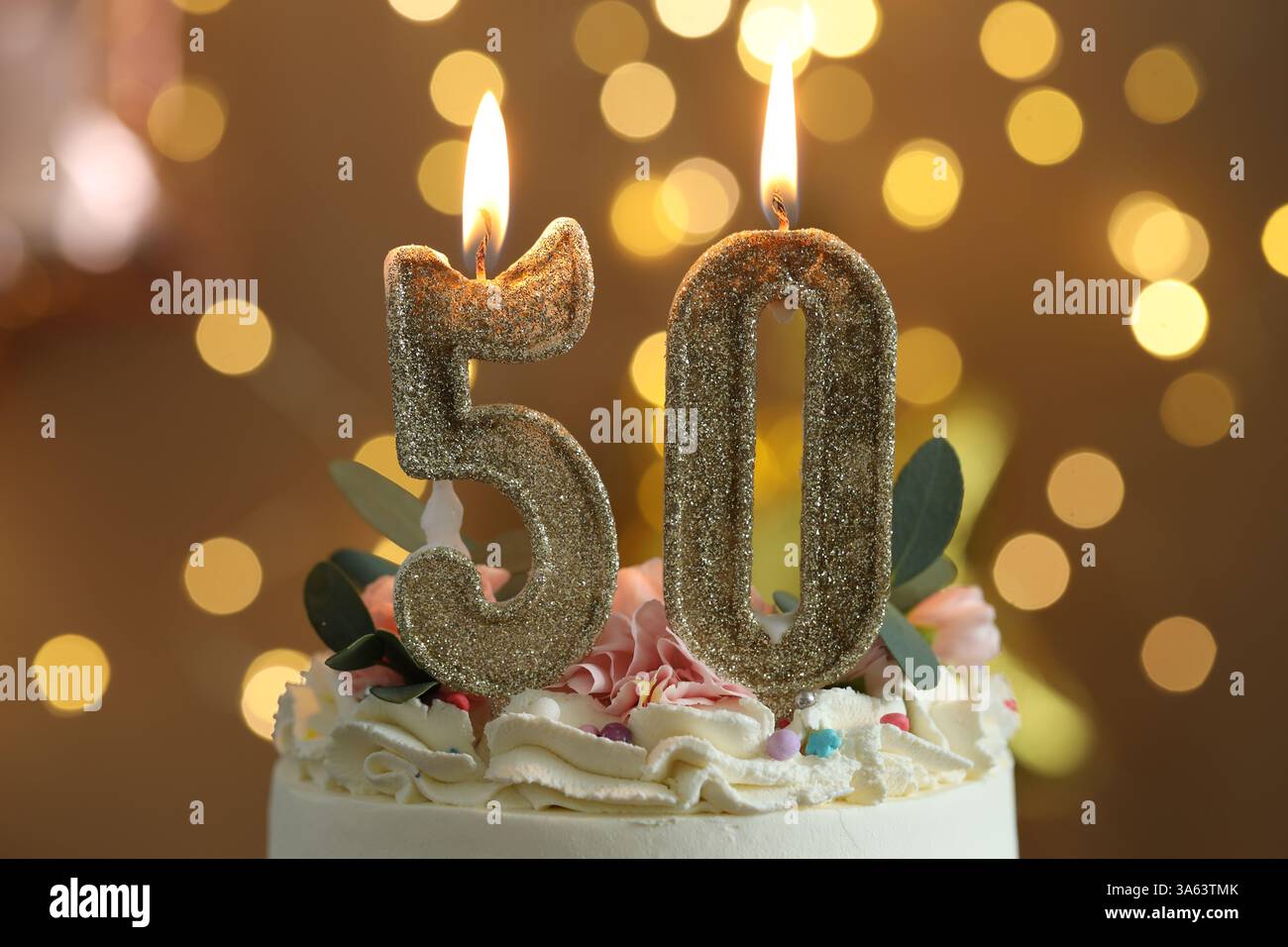 50th birthday. Tasty cake with burning number shaped candles and ...