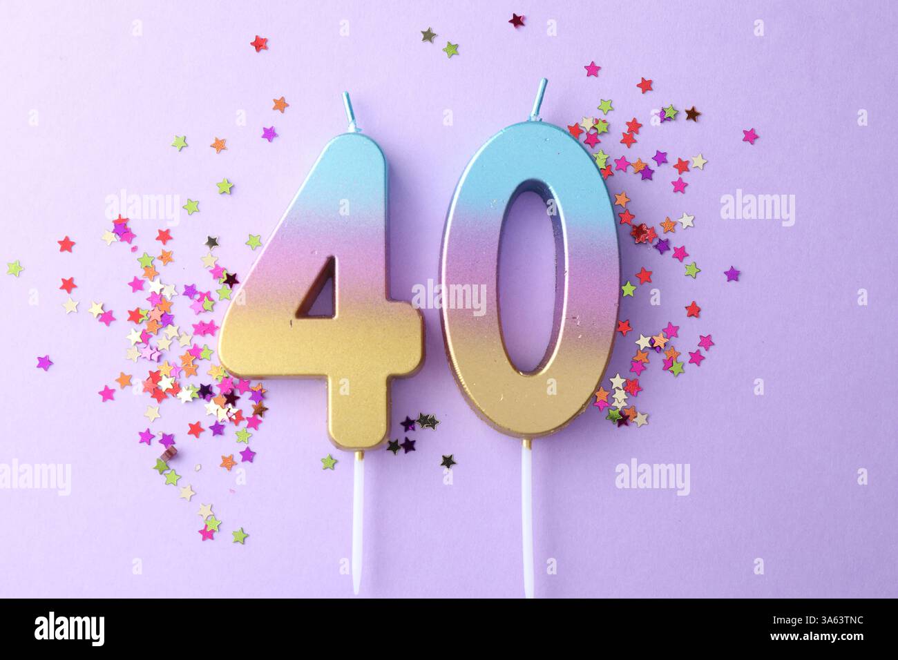 40th birthday. Number shaped candles and confetti on violet background ...