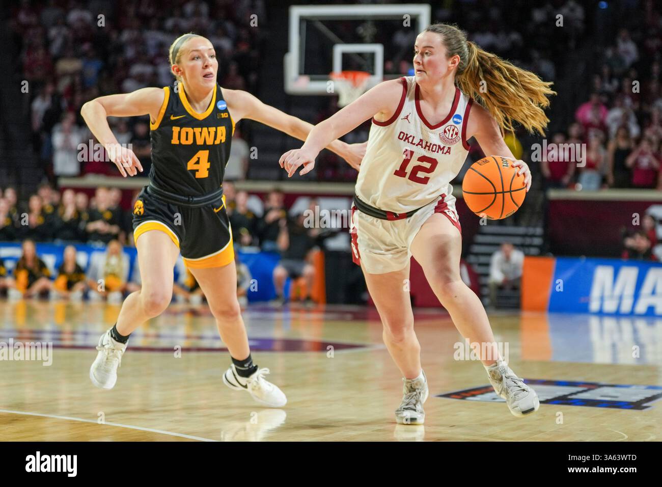 Oklahoma guard Payton Verhulst (12) drives past Iowa guard Kylie ...