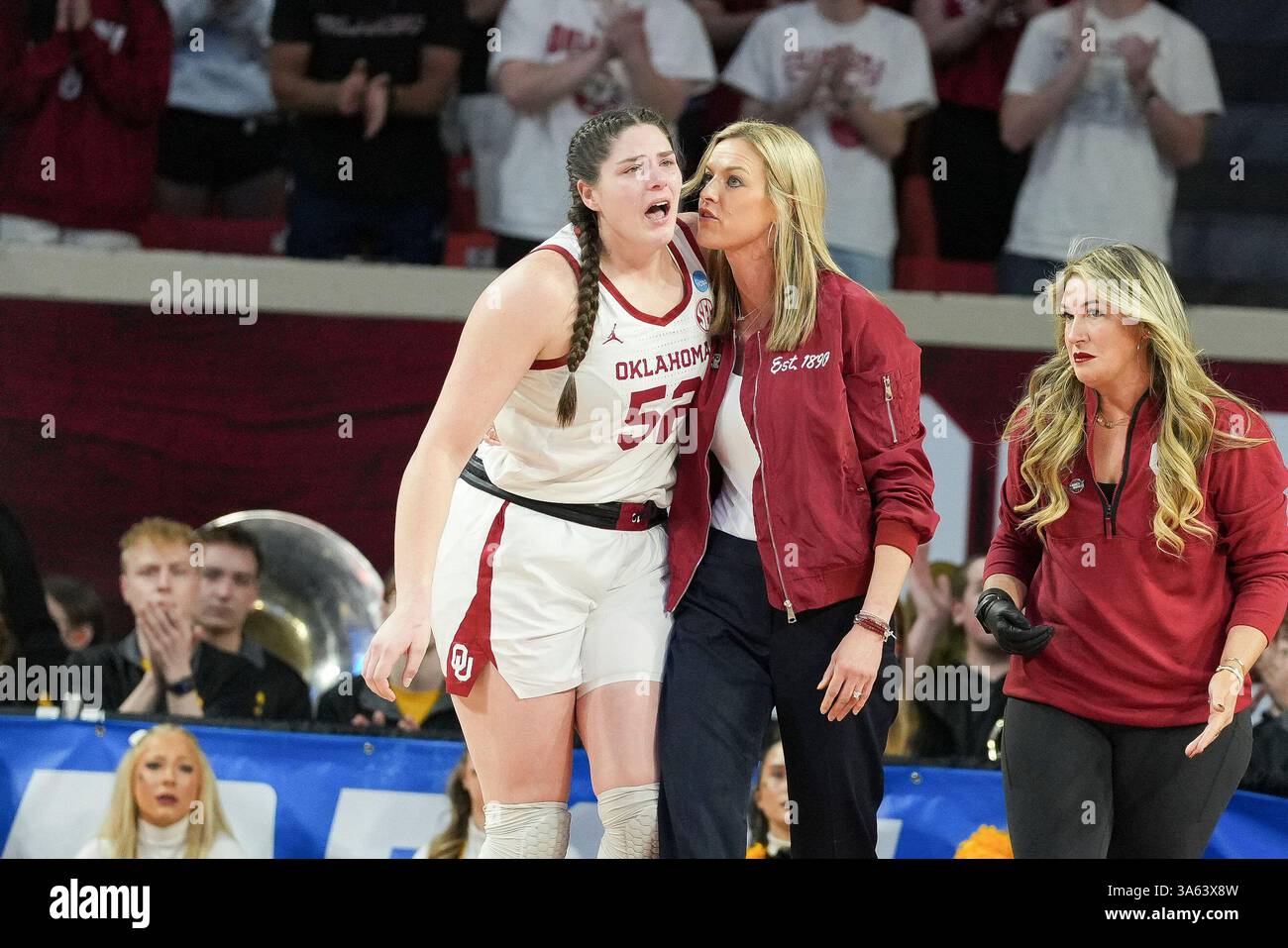 Oklahoma head coach Jennie Baranczyk, right, helps center Raegan Beers ...