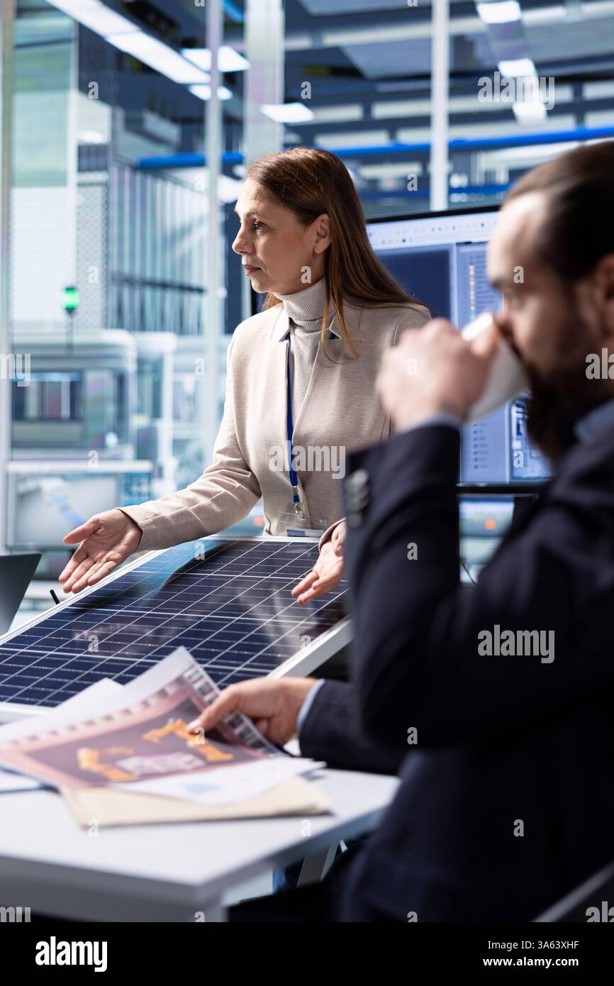 Photovoltaics factory industrial production managers looking over ...