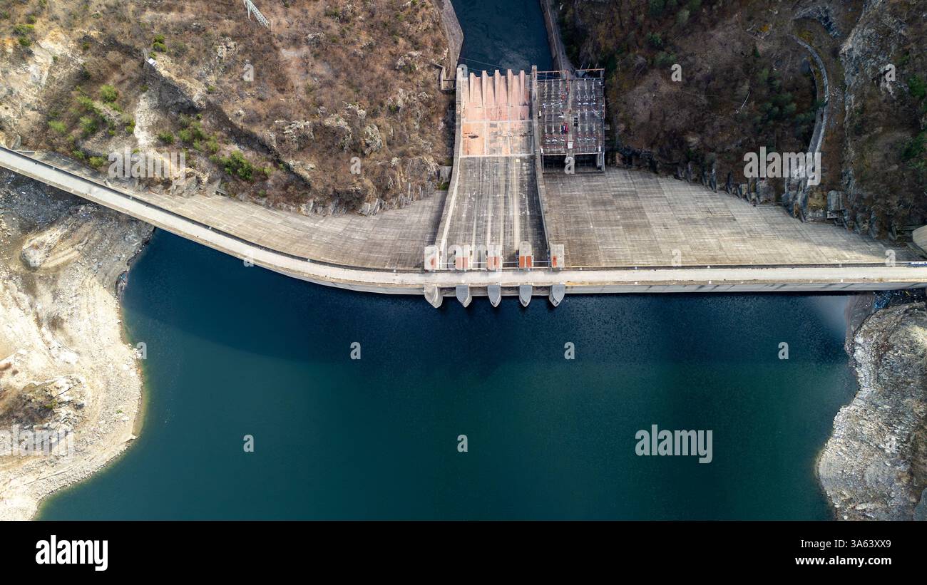 Concrete hydroelectric dam holding back a large body of water ...