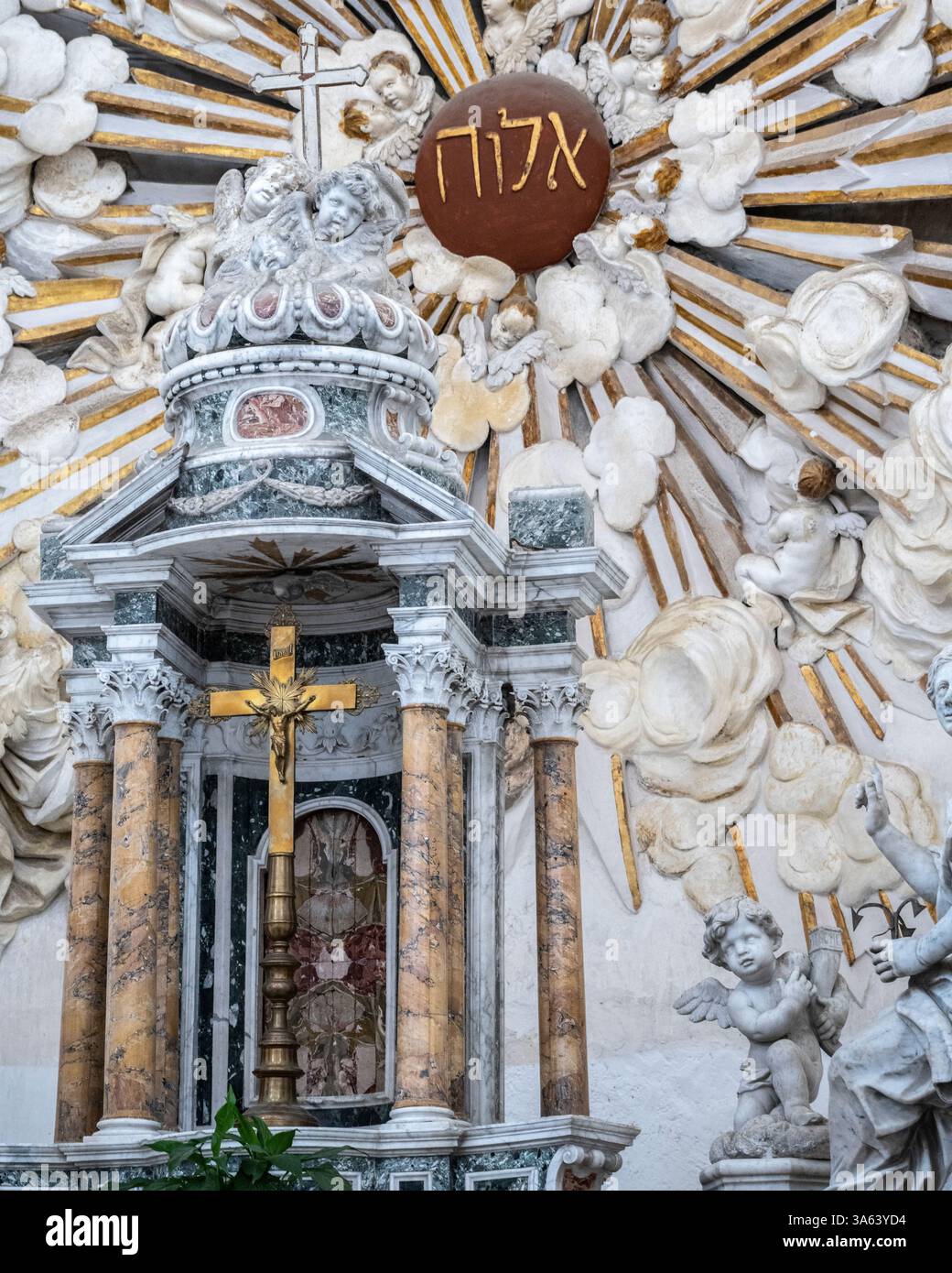 Crucifix on display surrounded by an embellished canopy of carvings and ...