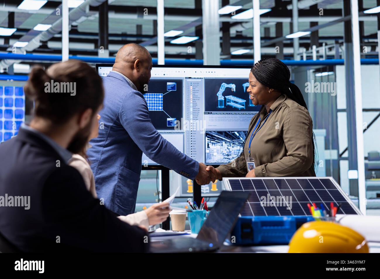 Solar panel factory manager shaking hands with investor interested in ...