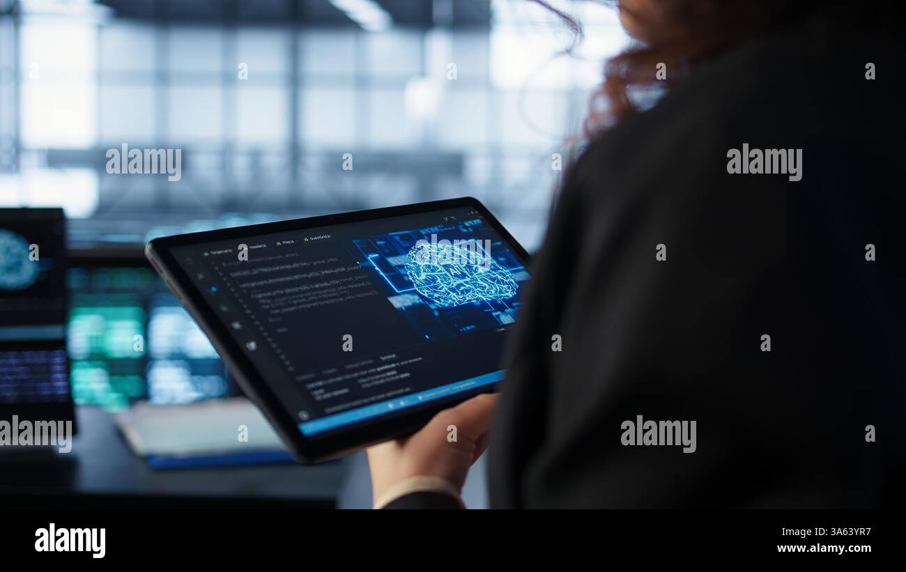 Data center technician using artificial intelligence on tablet to prevent vulnerabilities ...