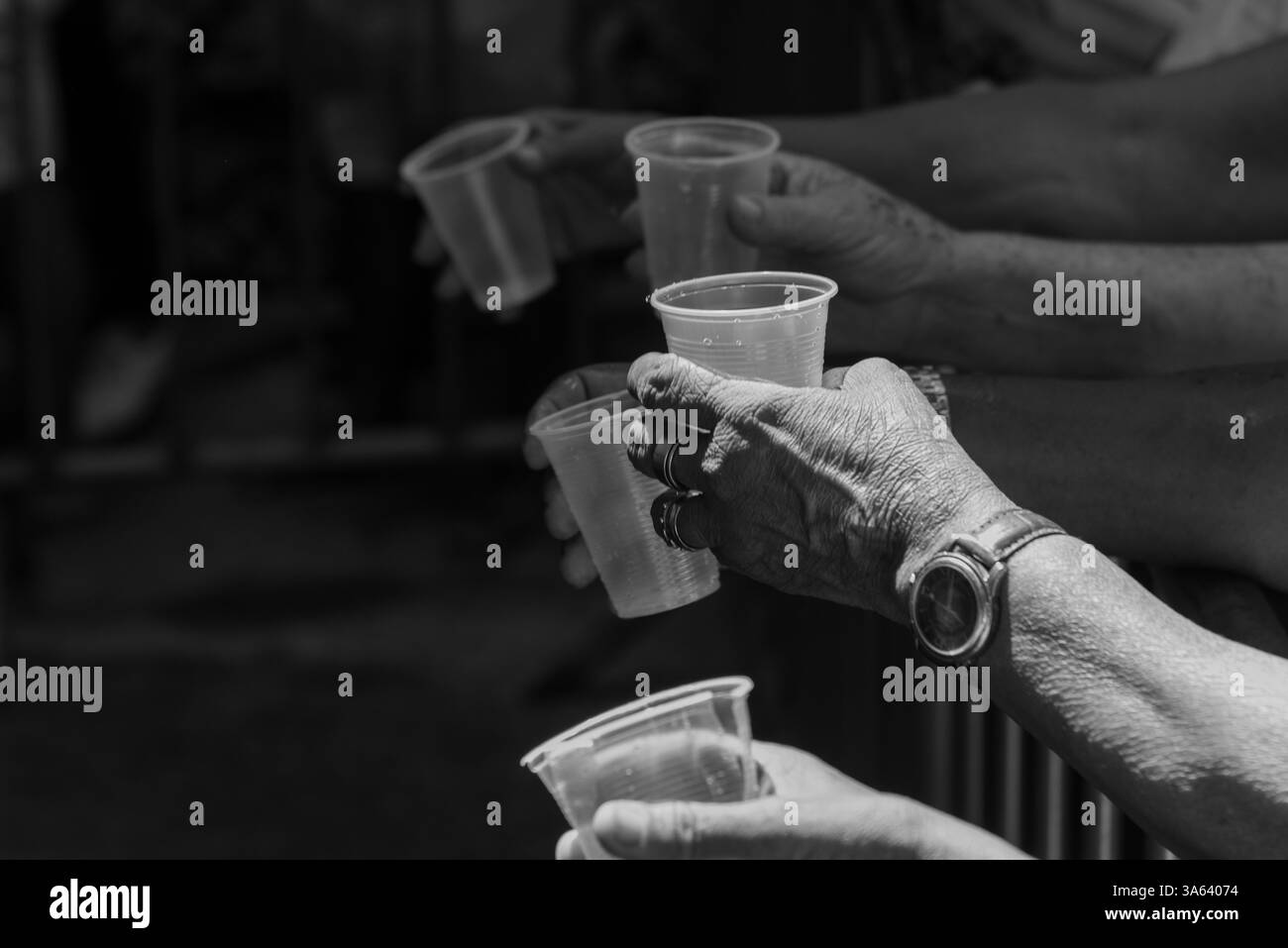 Black and white photo of people receiving water during a tribute to ...
