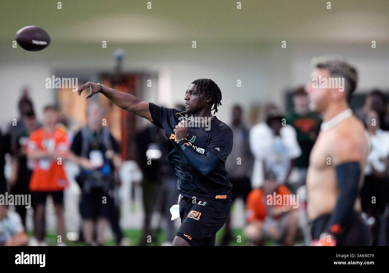 Miami quarterback Cam Ward, center, throws the ball during a drill at ...