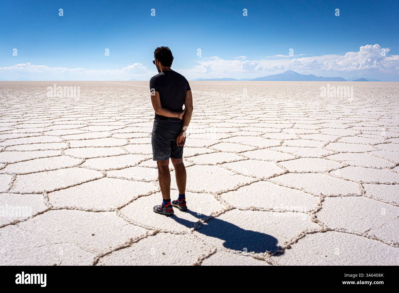 Tourist Standing on the Cracked Salt Surface of Salar de Uyuni Bolivia ...