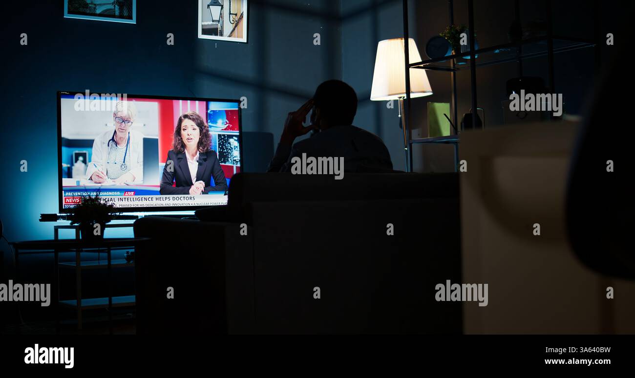 Curious spectator reading news coverage titles on smart tv set, sitting ...