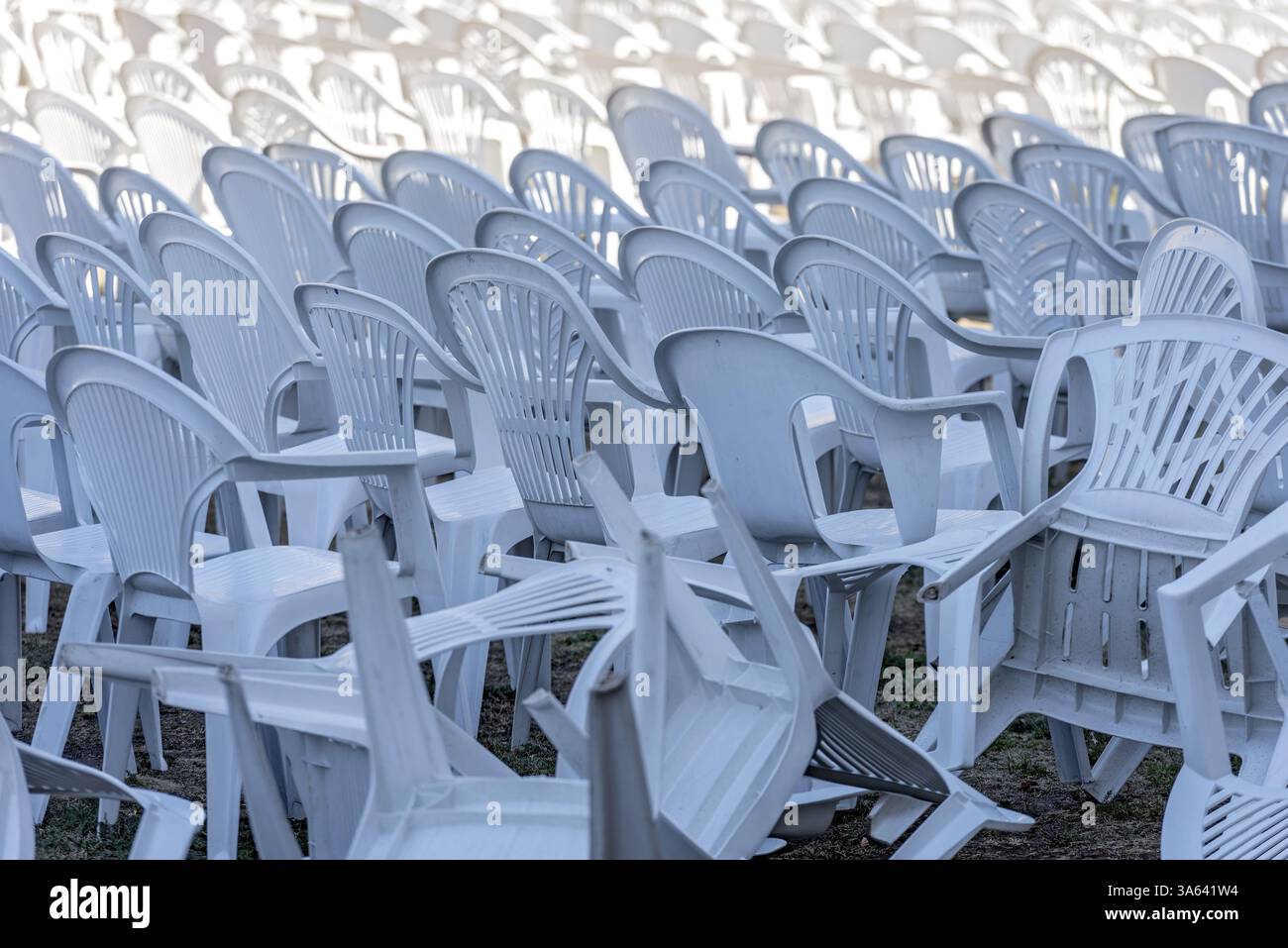 Seating for outdoor event, rows of chairs, overturned garden chairs ...