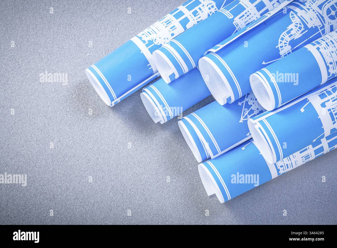 Rolls of blue construction plans on grey background maintenance concept ...