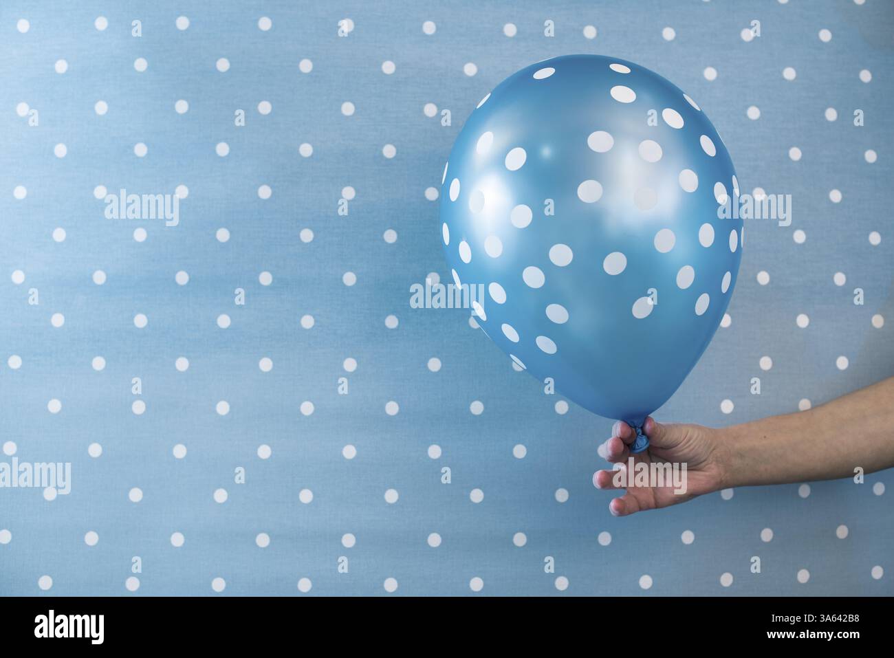 Balloon with white points on blue background Stock Photo - Alamy