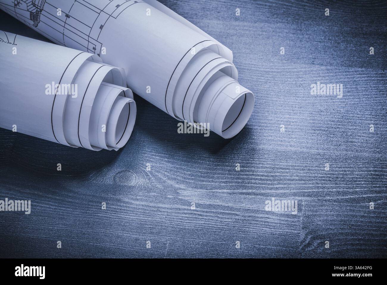 Rolled white blueprints on wood board Stock Photo - Alamy