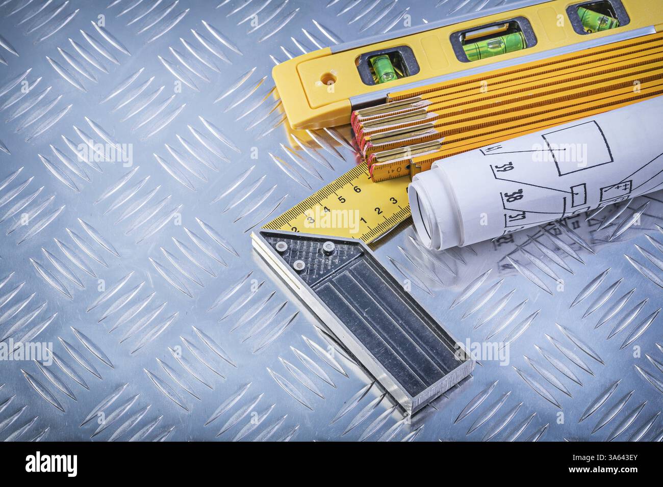 Blue construction drawings level wooden meter square ruler on grooved ...