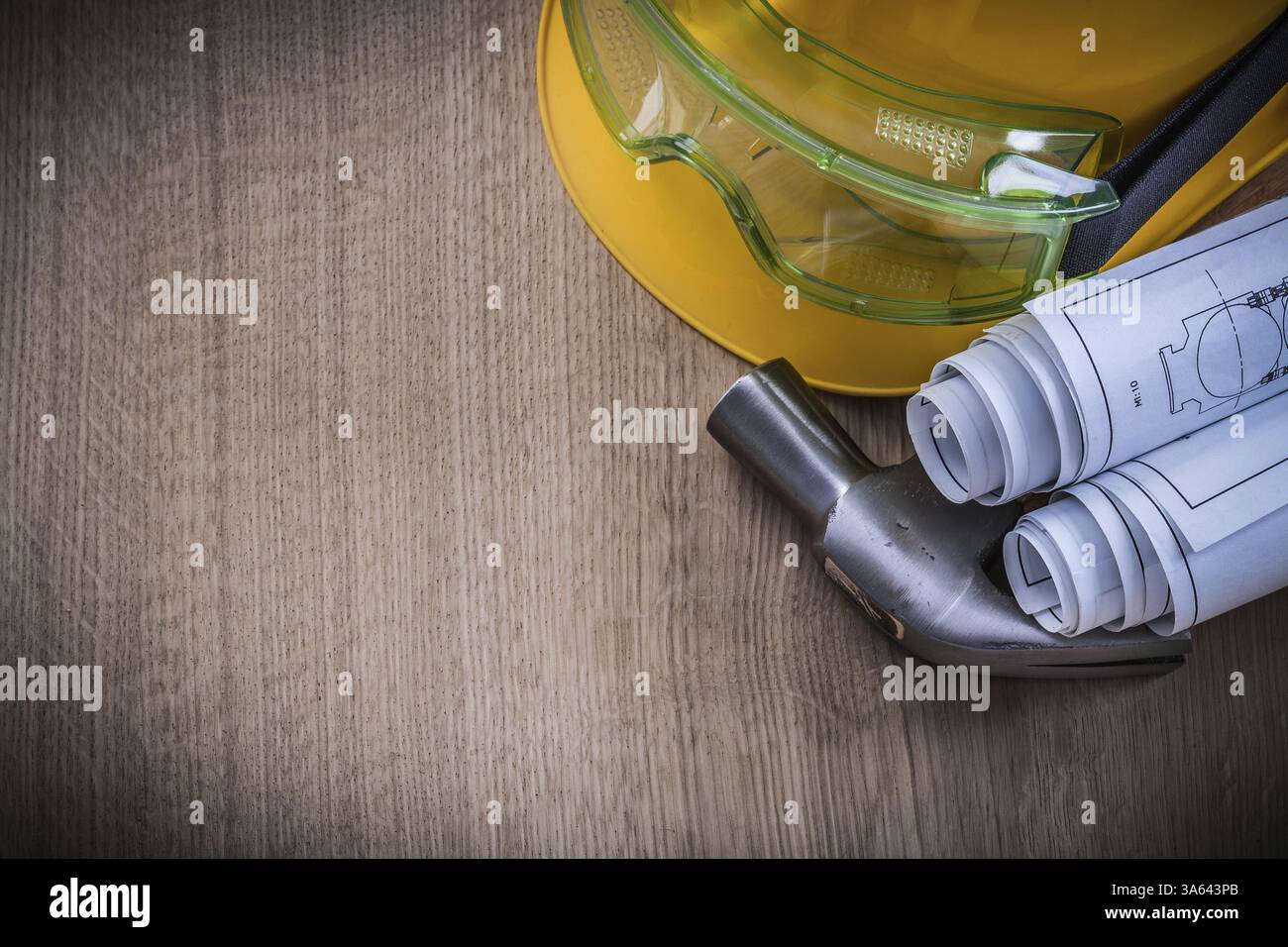 Claw hammer goggles blueprints and hard hat on wooden board Stock Photo ...