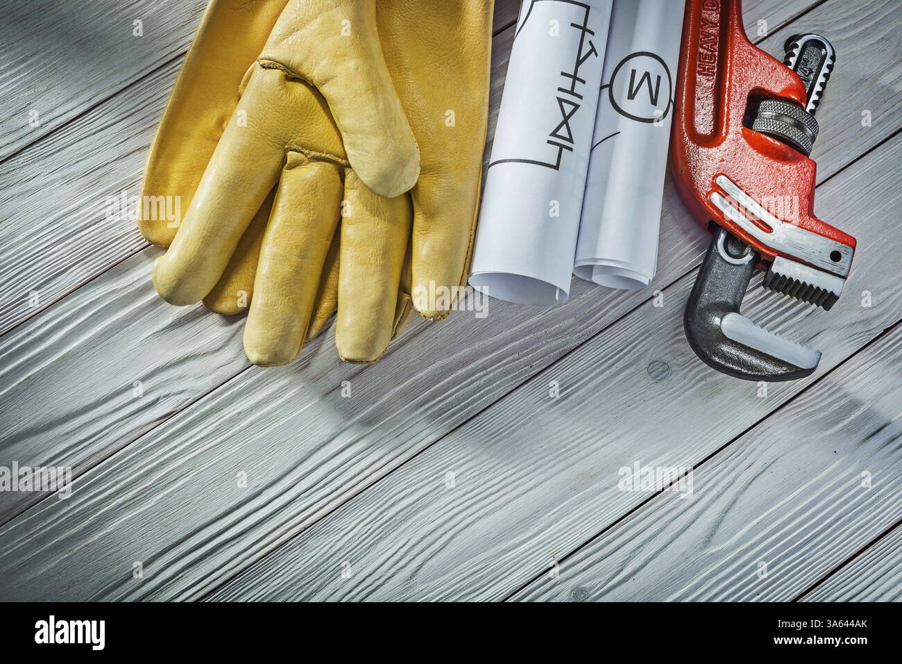 Plumbing engineering rolled piping blueprints pipe wrench yellow ...