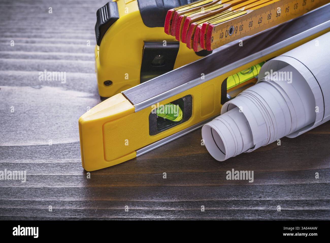 Composition of tape-measure blueprints construction level and wooden ...
