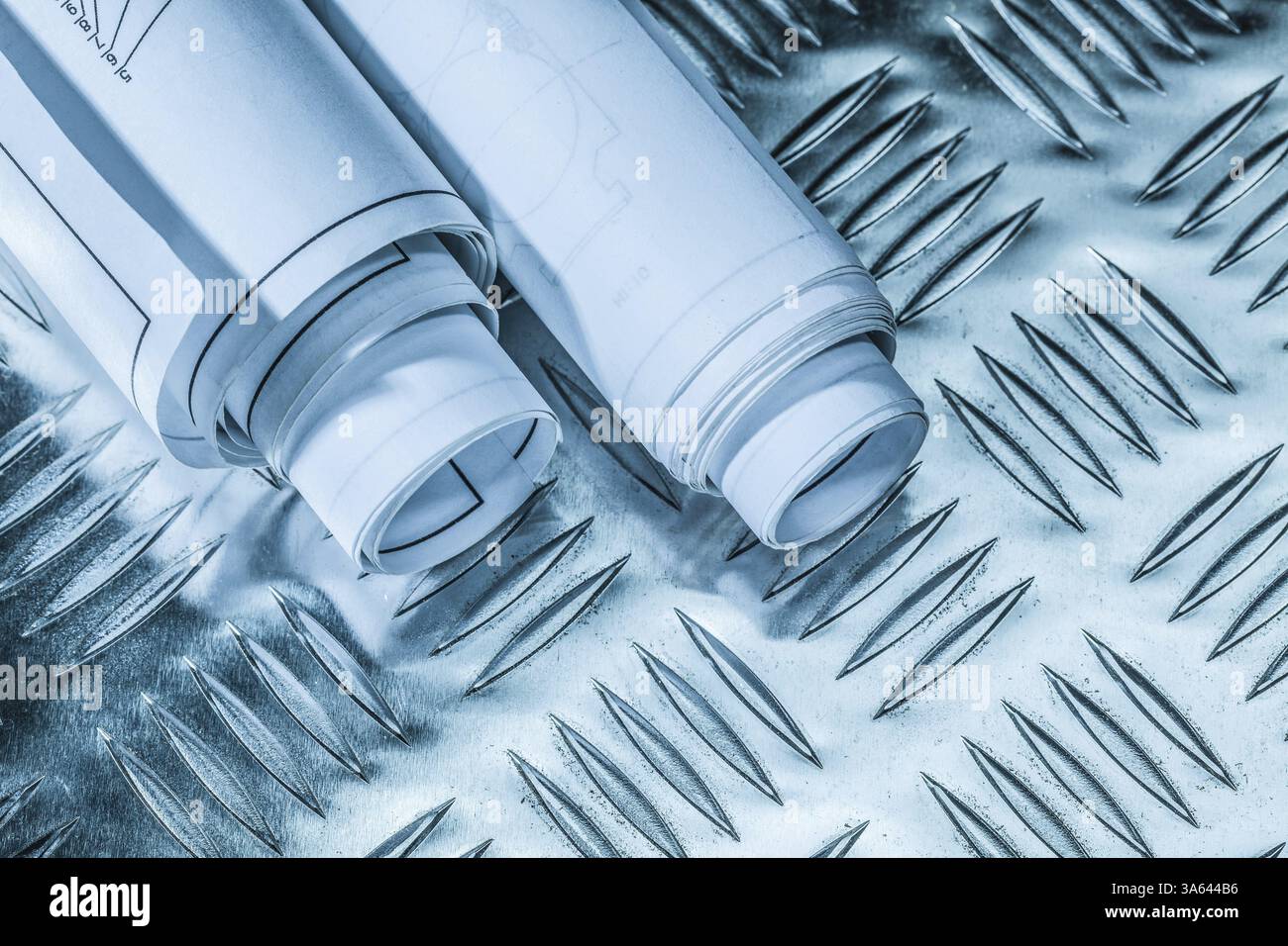 Rolled construction plans on channeled metal sheet Stock Photo - Alamy