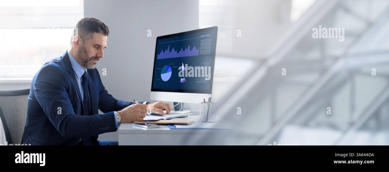 Successful businessman working diligently at his office desk Stock ...