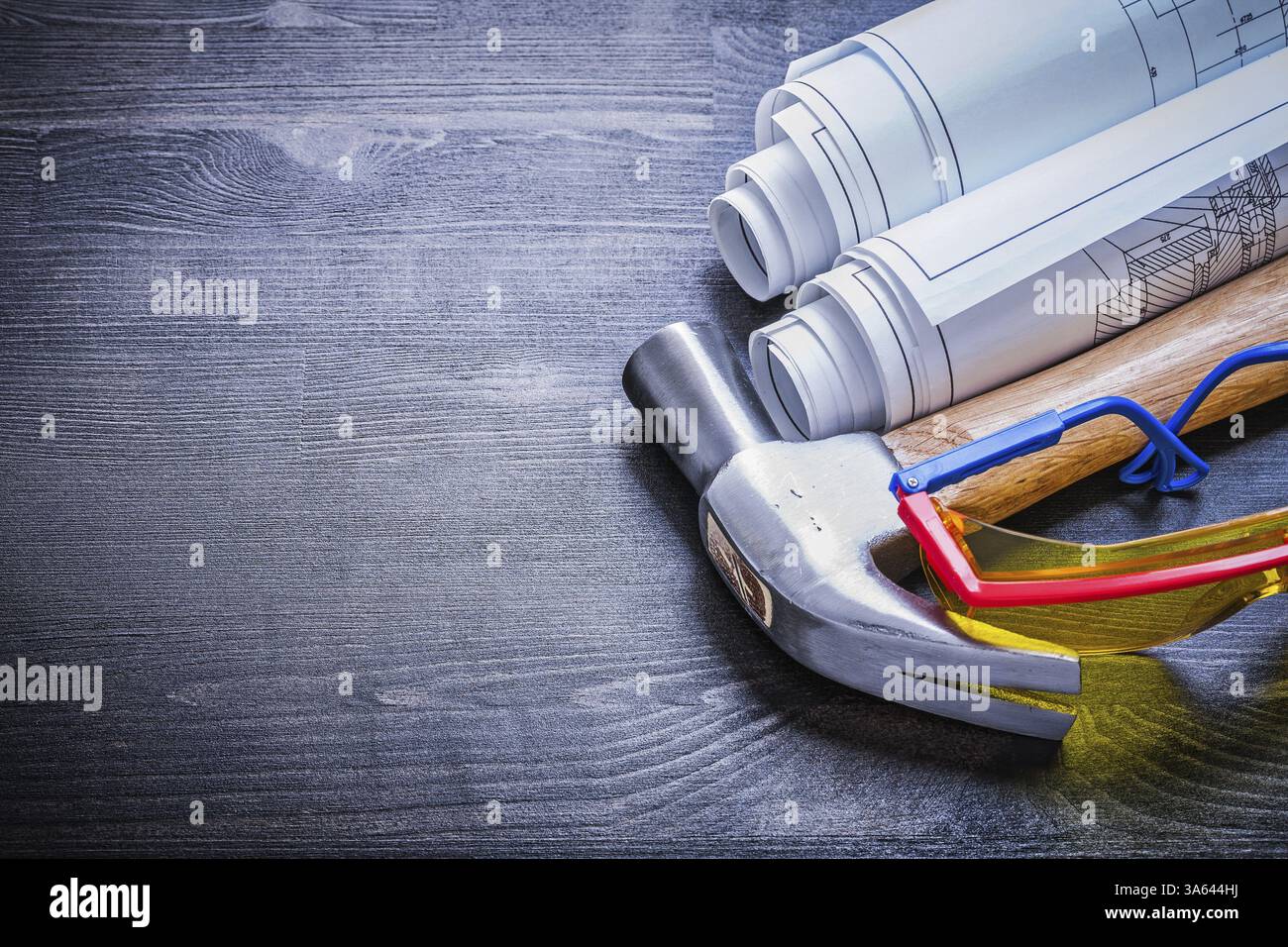 Blueprints hammer goggles on wood board Stock Photo - Alamy