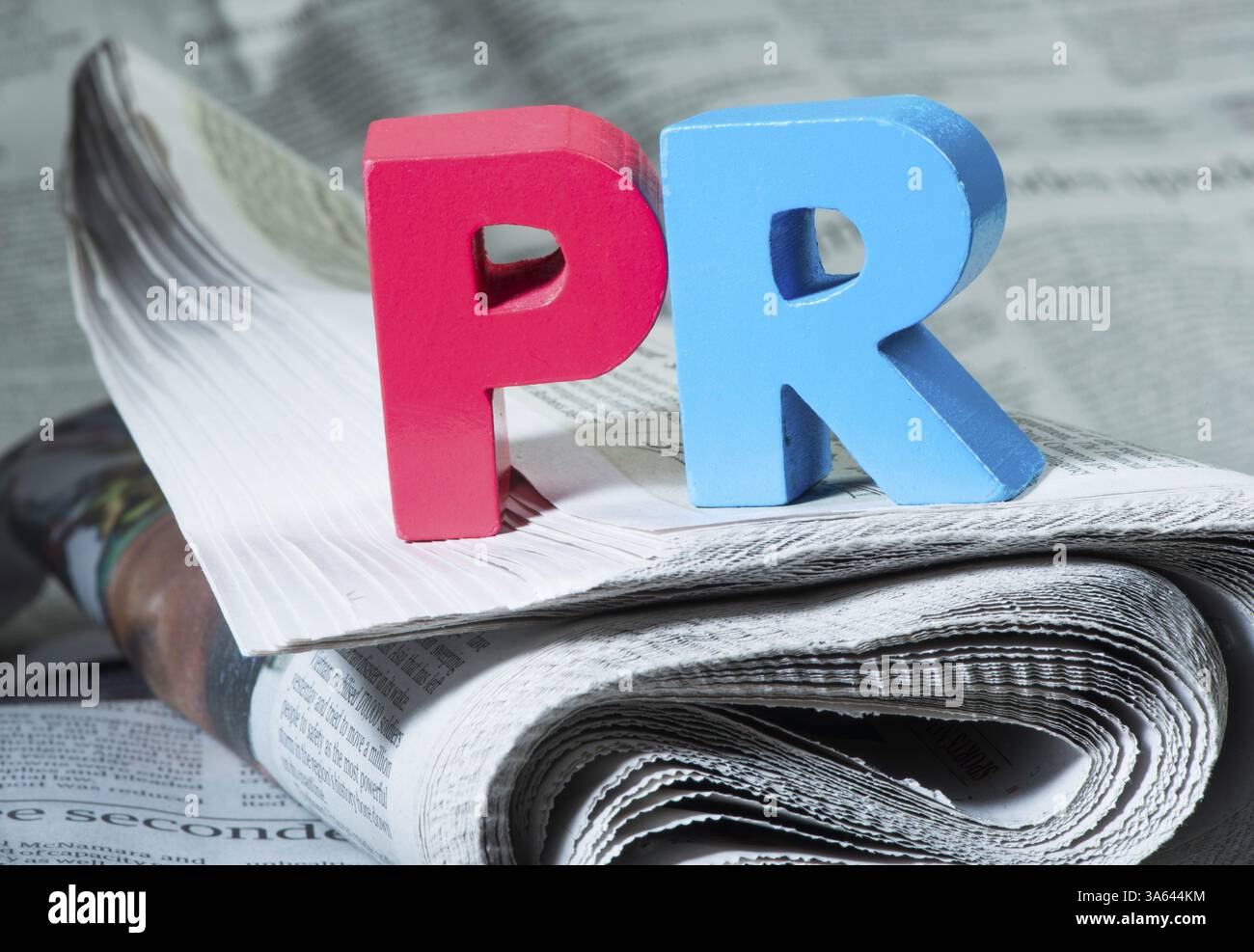 Word PR on newspaper. Wooden letters Stock Photo - Alamy