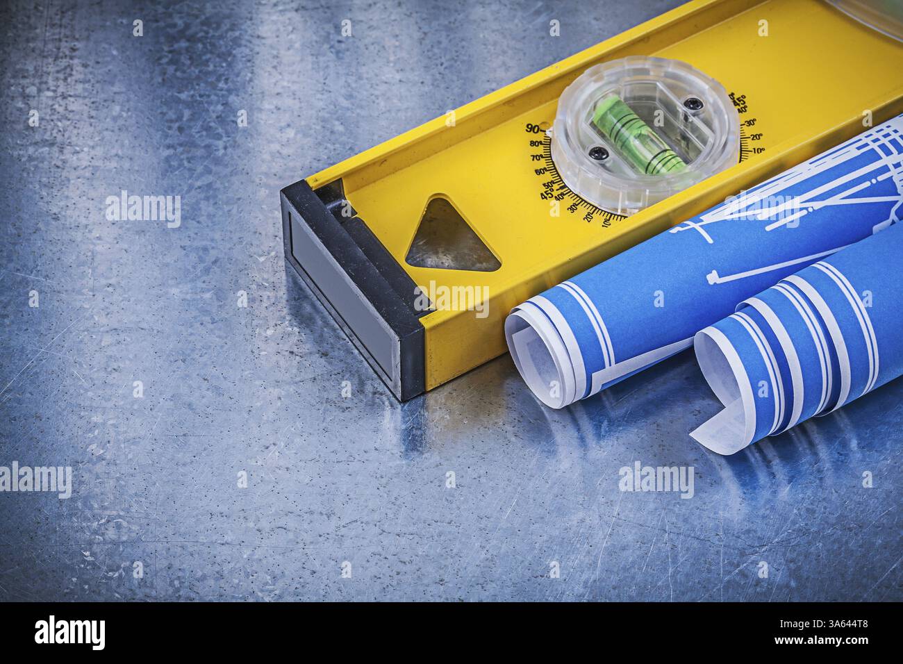 Blue engineering drawings construction level on metallic background ...