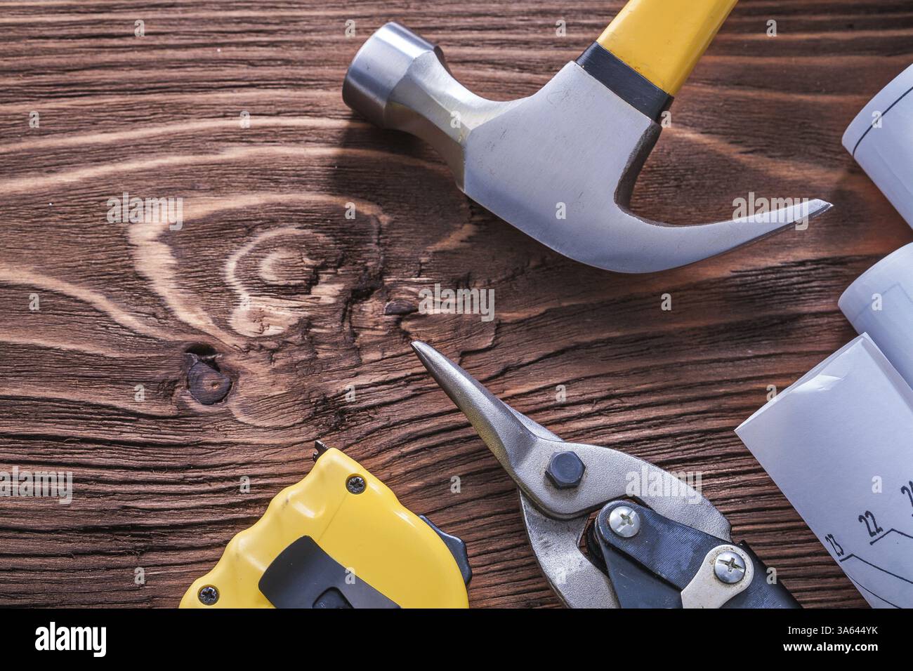 Claw hammer blueprints nippers and tape-measure on wood board ...