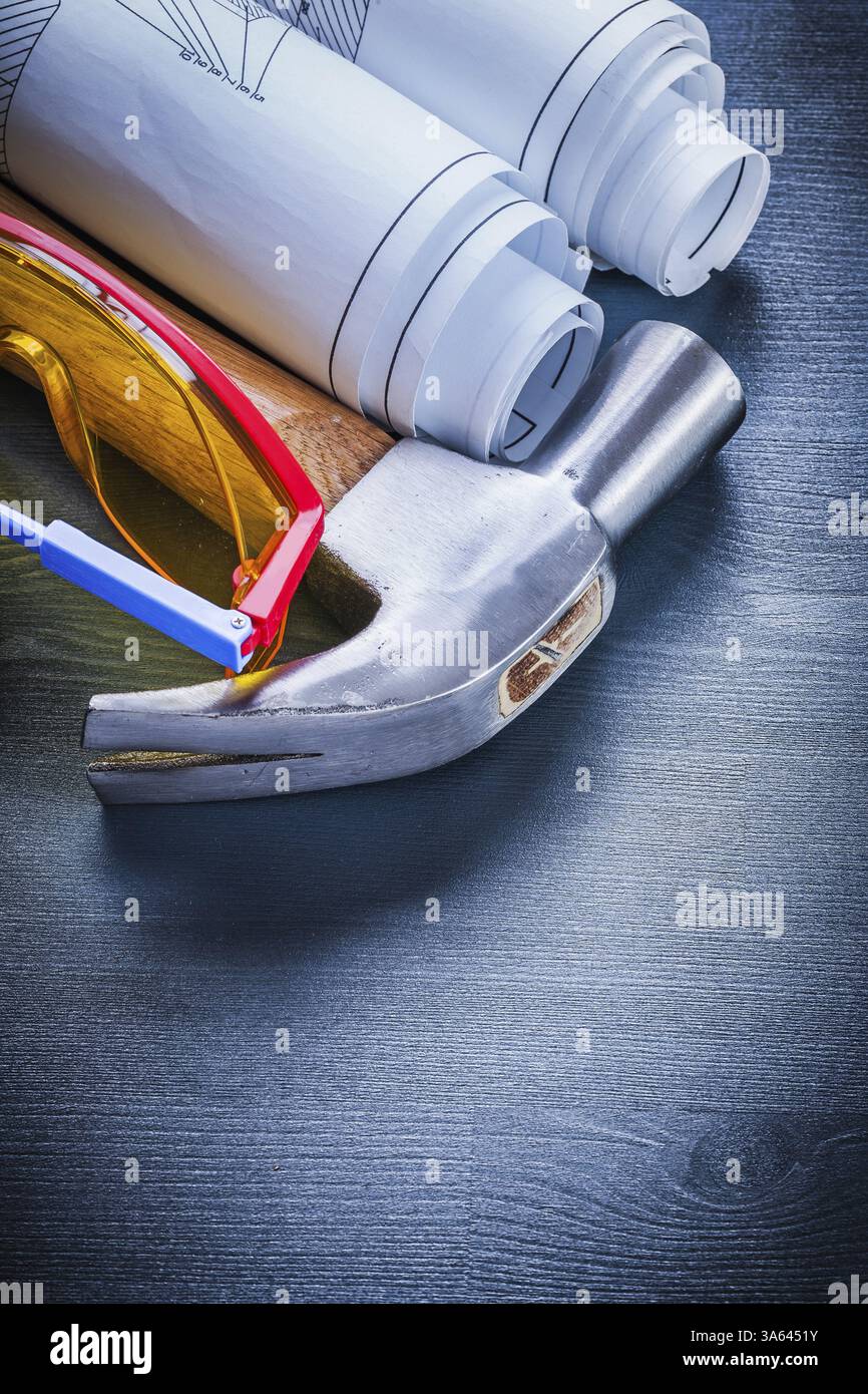 Close up rolled up blueprints hammer goggles Stock Photo - Alamy