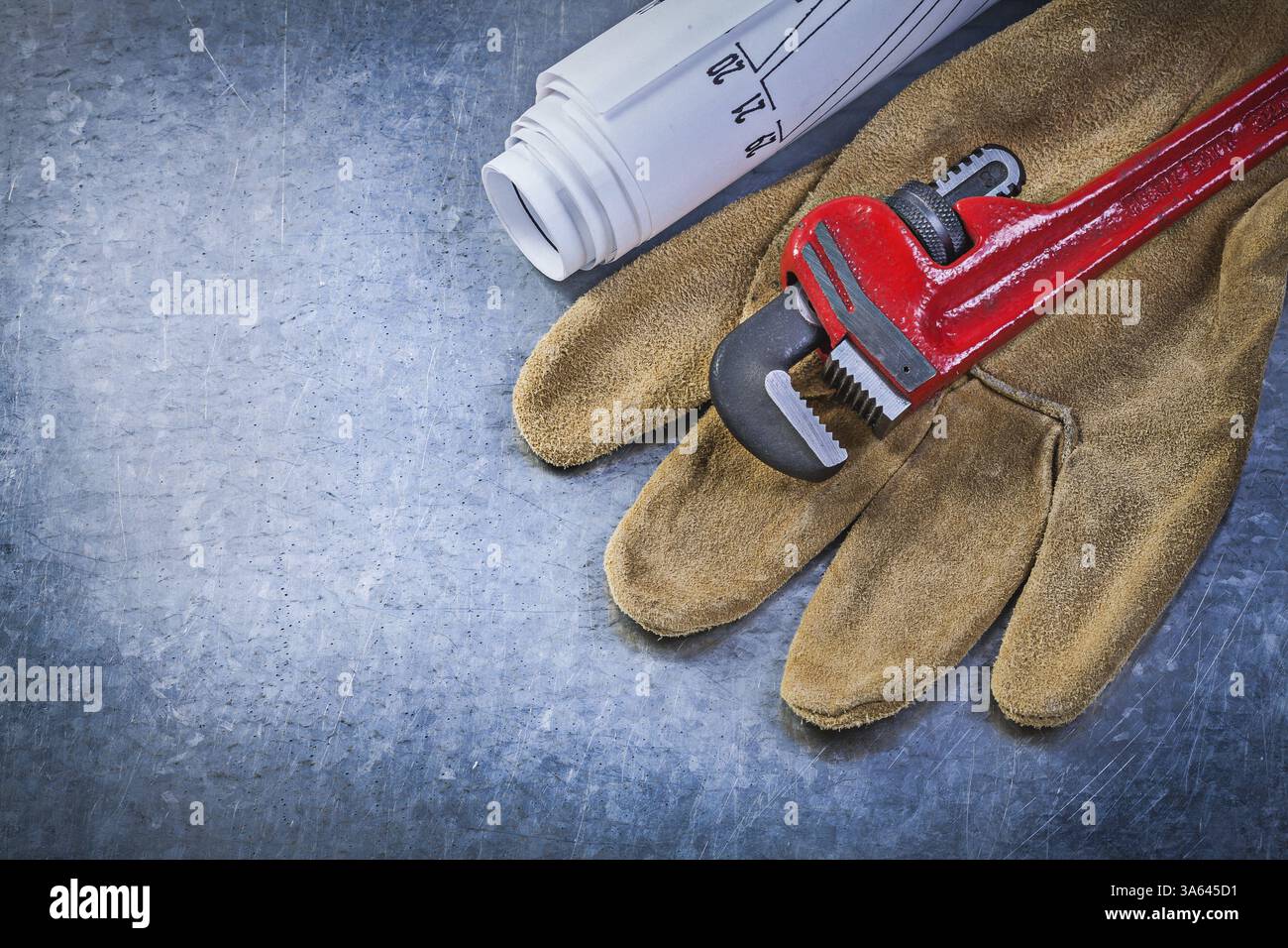 Pipe wrench protective gloves blueprints on metallic background ...