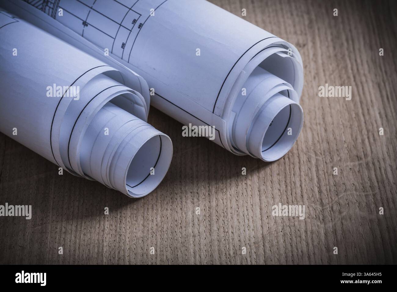 Rolled blueprints on wooden background horizontal version construction ...