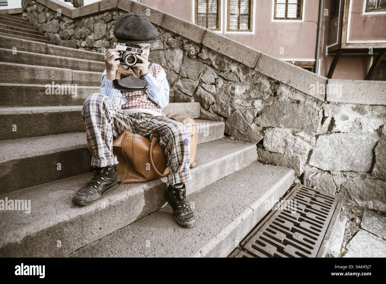 Child with vintage camera. Exterior stairs Stock Photo - Alamy