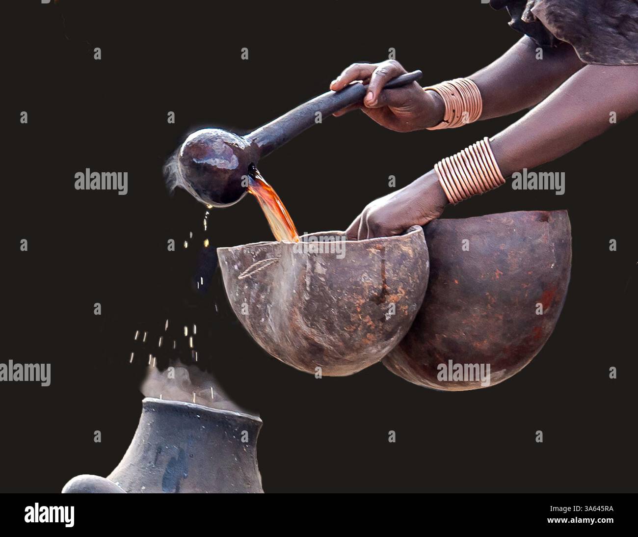 Ethiopia, a woman prepares the local beverage in a village of the Hamer ...