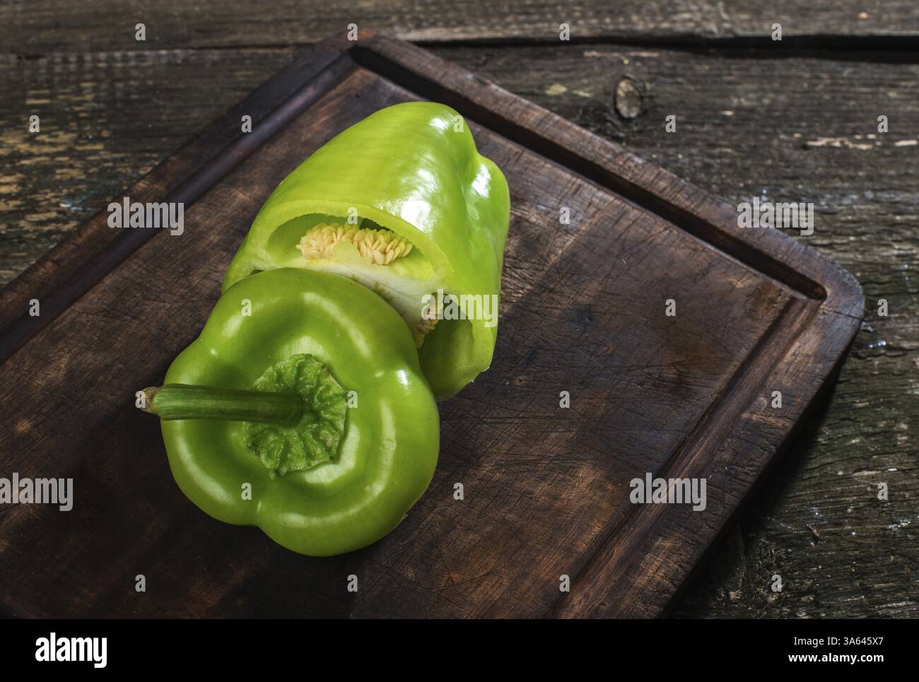 Cut green pepper on wood. Backlight Stock Photo - Alamy