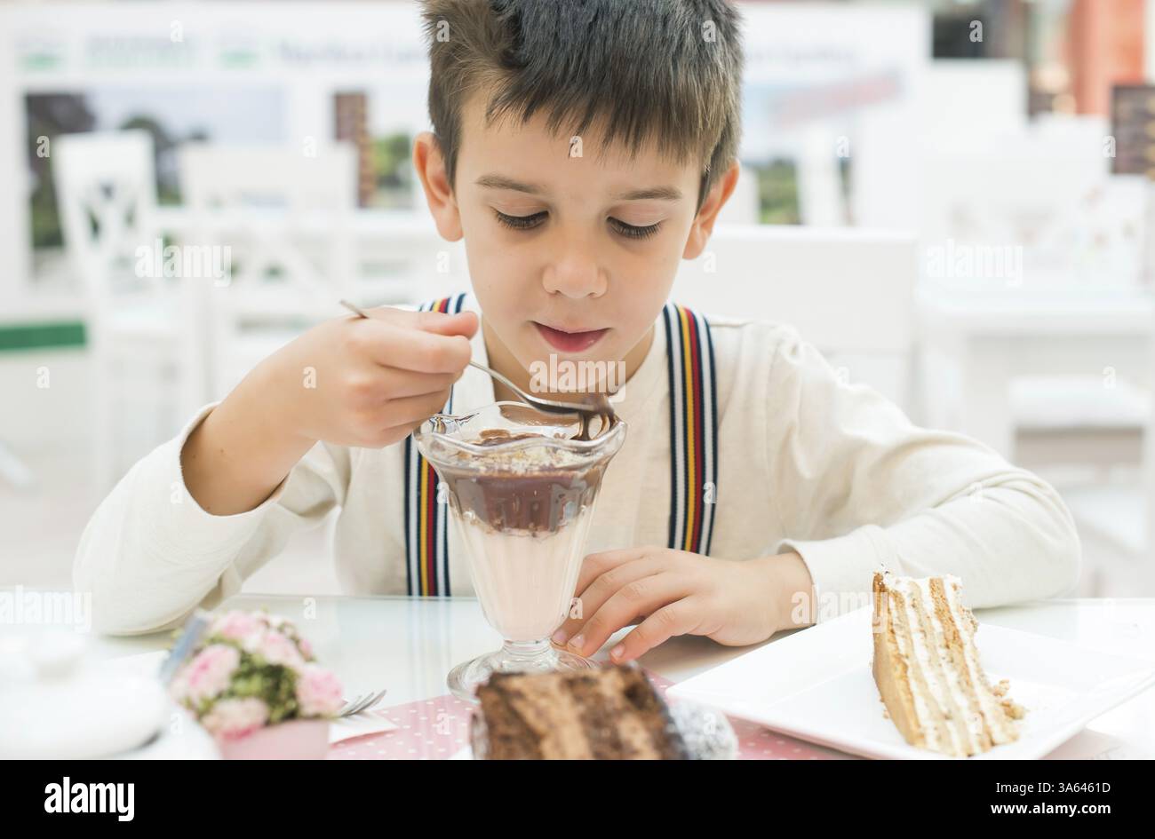 Child eat milk choco shake on a table Stock Photo - Alamy