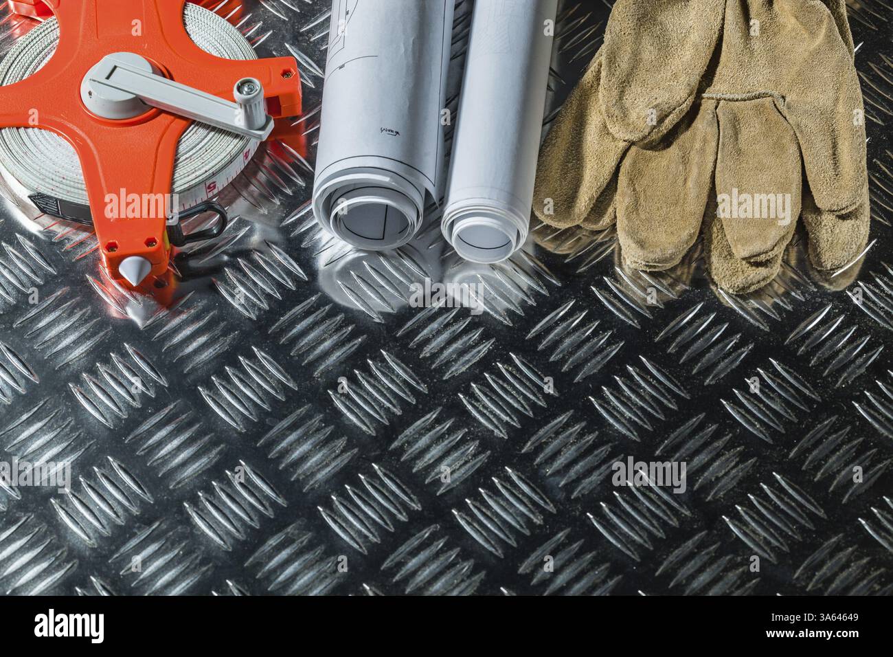 Construction plans safety gloves measuring tape on fluted metal sheet ...