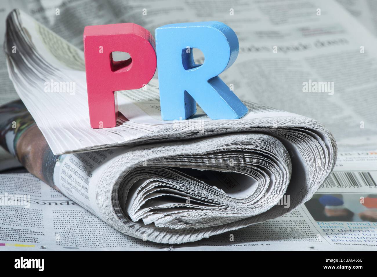 Word PR on newspaper. Wooden letters Stock Photo - Alamy