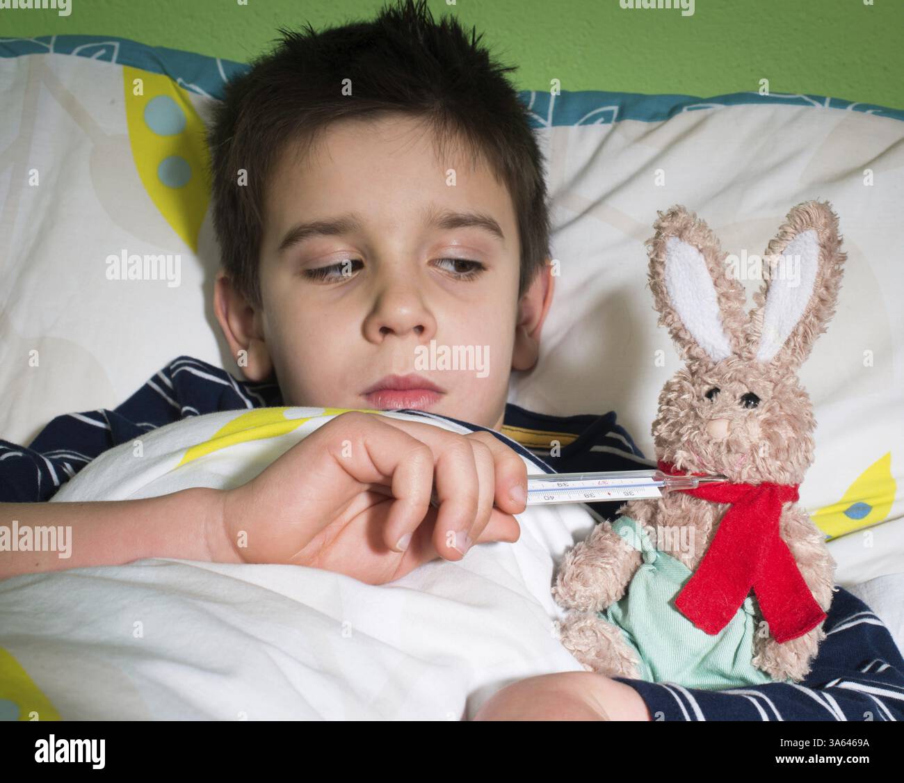 Sick child in bed with teddy bear. Measuring the temperature with a thermometer Stock Photo - Alamy