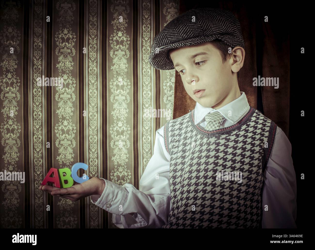 Child in vintage clothes hold multicolor letters a b c Stock Photo - Alamy
