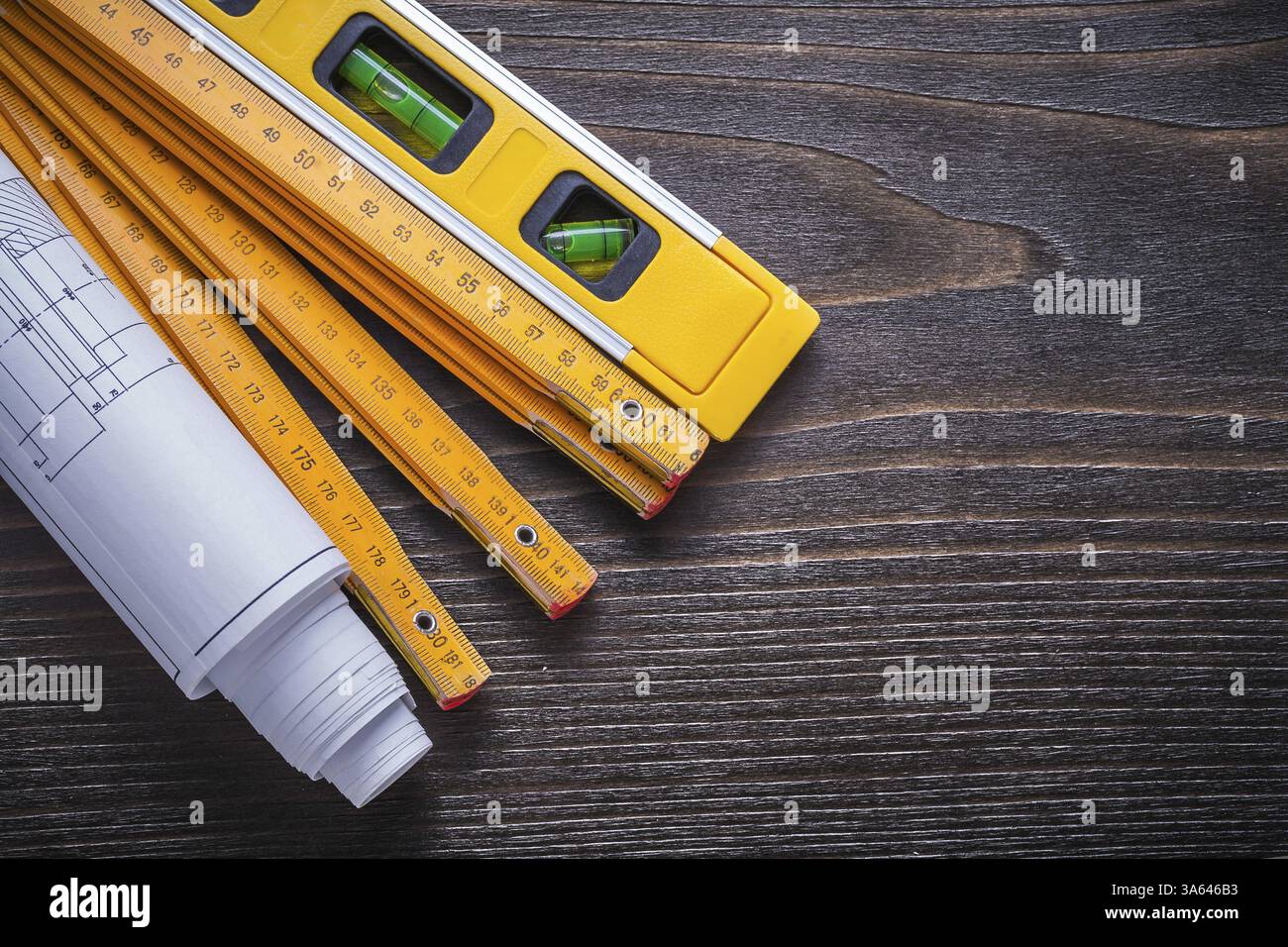 Blueprints construction level and wooden meter on vintage wood board ...