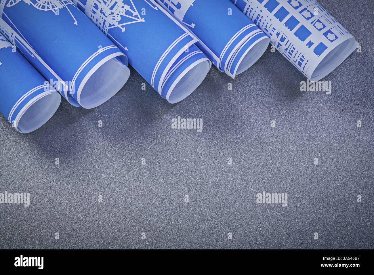Rolls of blue engineering drawings on grey background construction ...