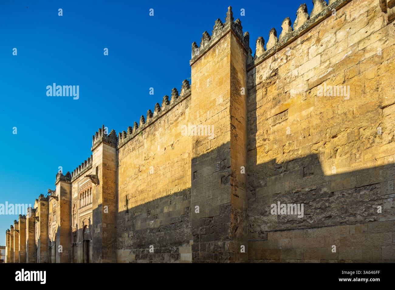 Visitors admire the impressive eastern wall of the historic Mosque of ...
