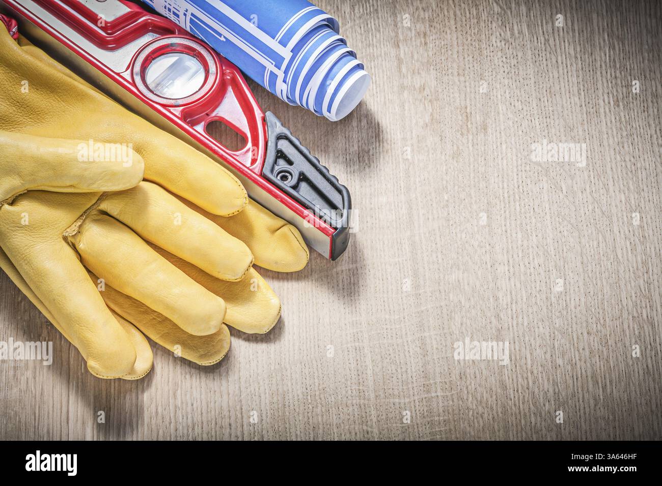 Protective gloves construction level drawings on wood board Stock Photo ...