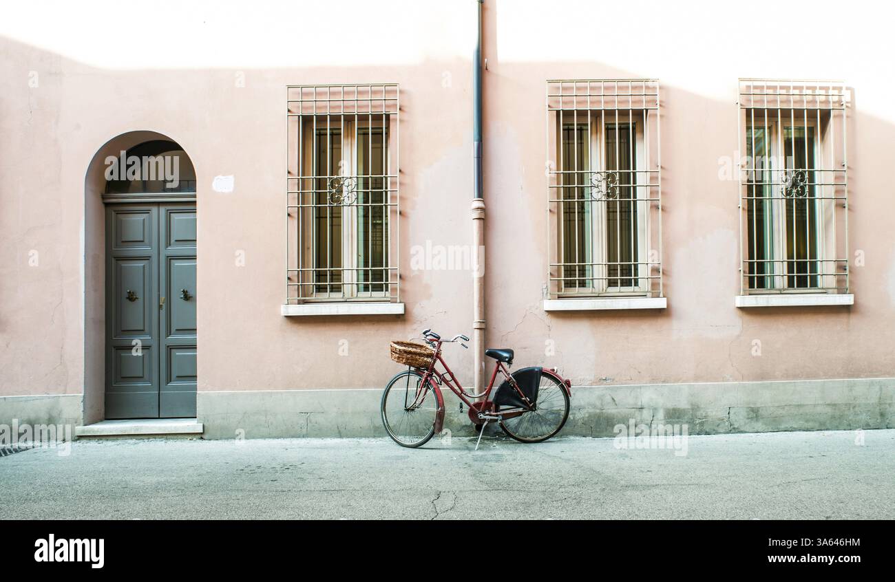 Red old Italian bicycle on sunlight. Ancient buildings Stock Photo - Alamy