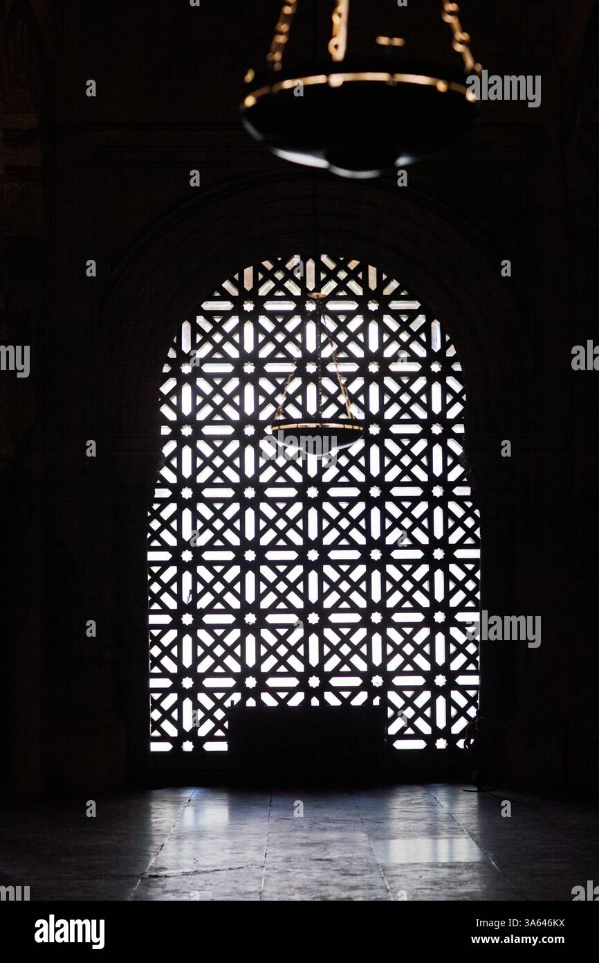 A stunning lattice window frames intricate patterns in the Mosque of ...