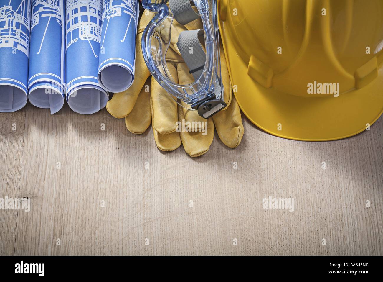 Building helmet protective gloves glasses rolled engineering drawings ...
